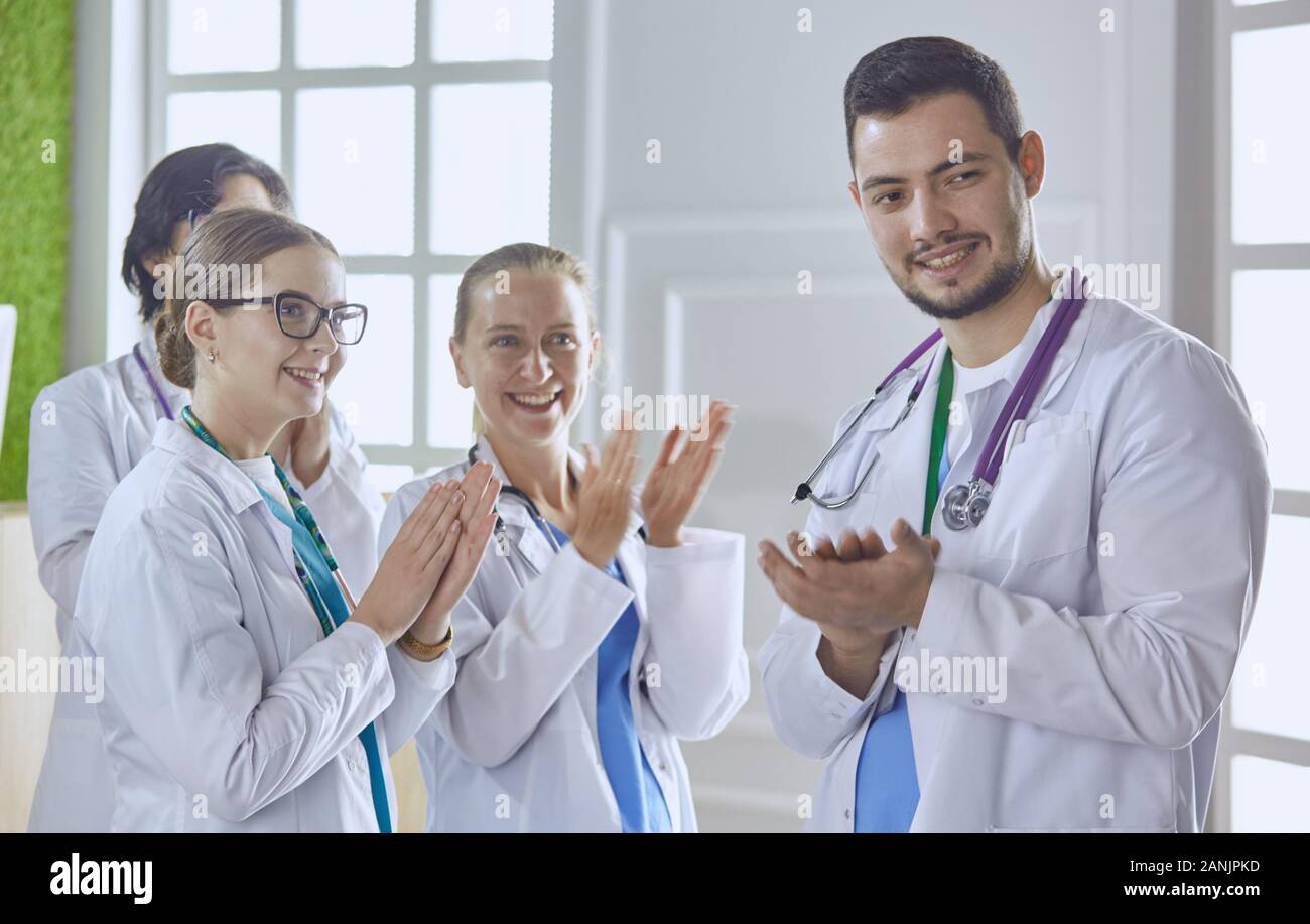 Happy medical team comprising male and female doctors smiling broadly ...