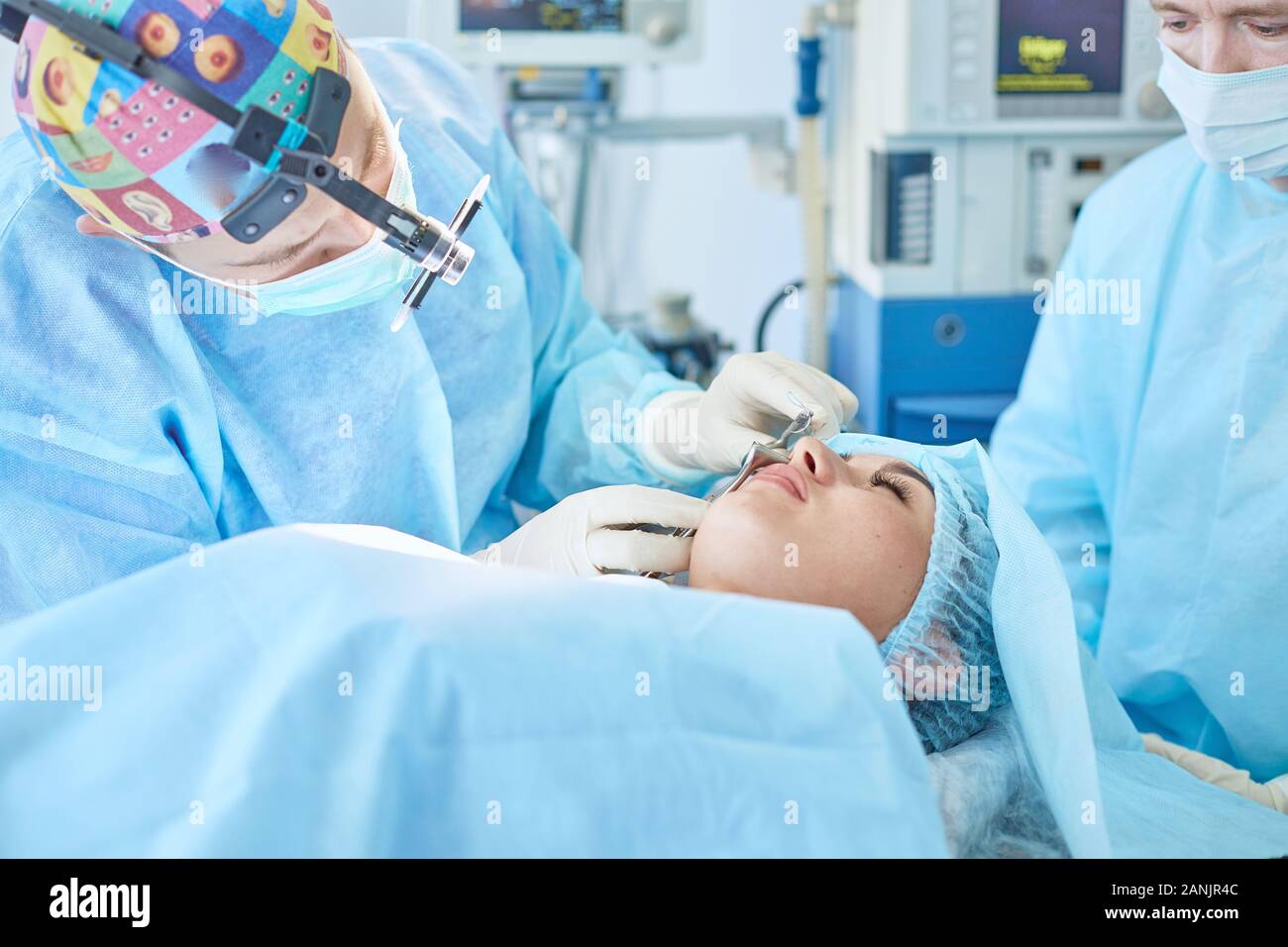 Several doctors surrounding patient on operation table during their ...