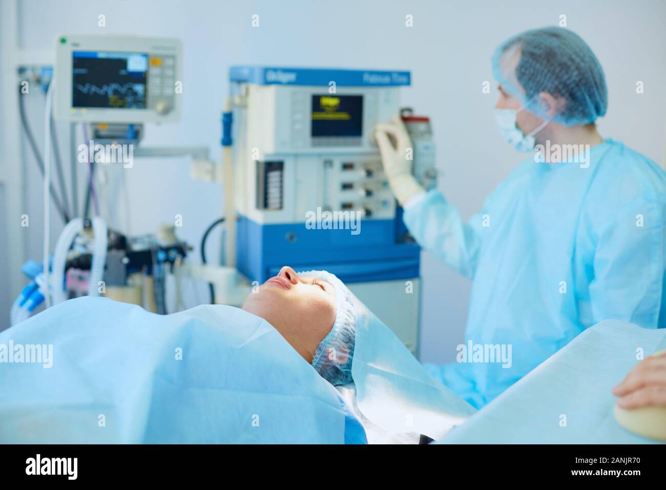Several doctors surrounding patient on operation table during their ...