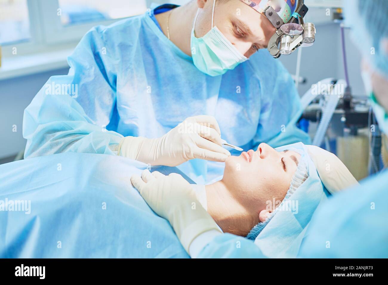 Several doctors surrounding patient on operation table during their ...