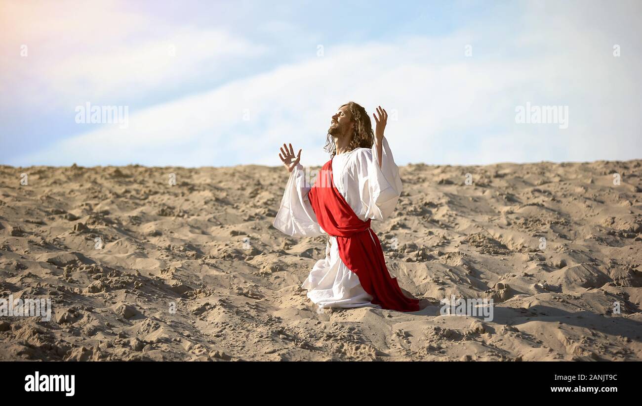 Saint man praying to God in desert, asking salvation, faith in better ...