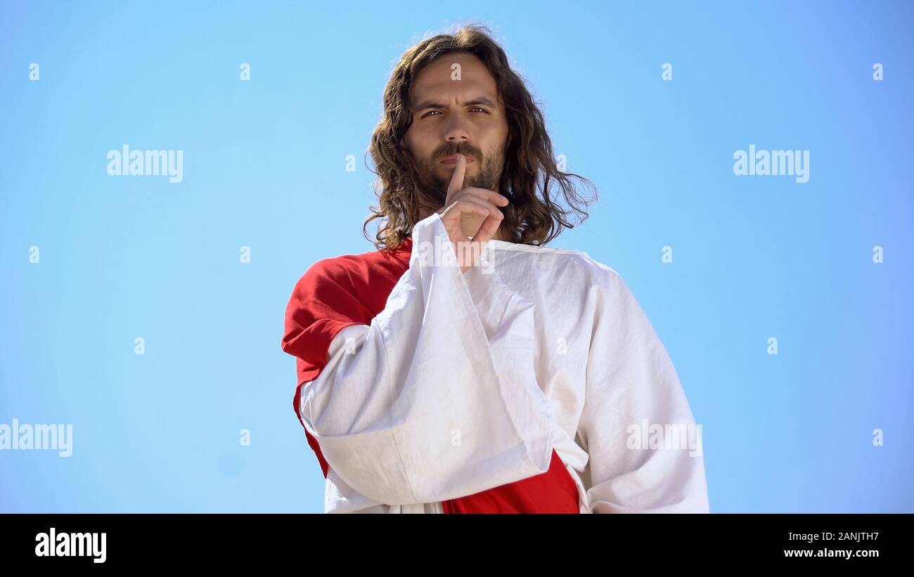 Jesus showing silence gesture on sky background, speechless prayer ...