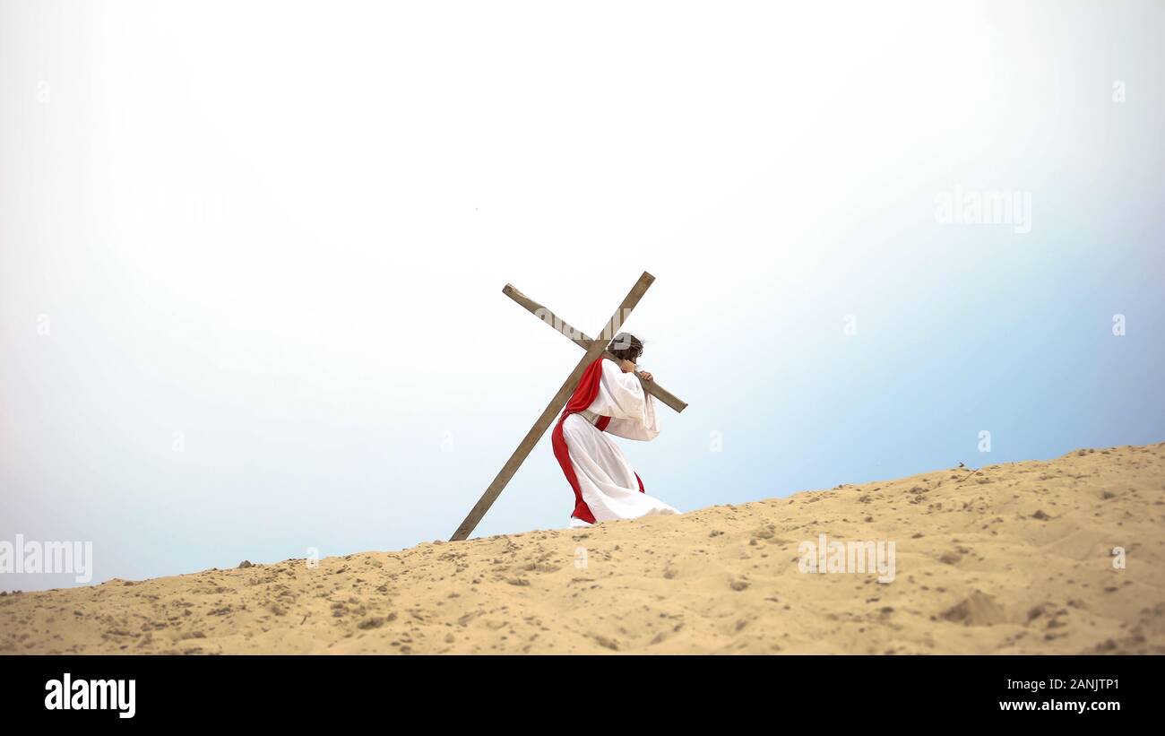 Historical personification of Jesus Christ carrying wooden cross ...