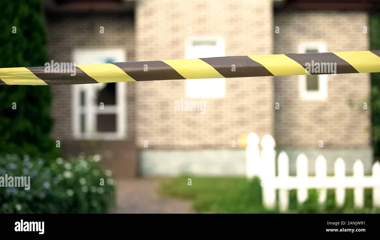 Big house fenced with black-yellow barricade tape, facade restoration ...