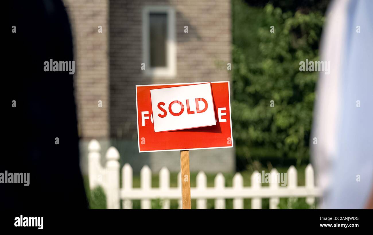 Sold signboard in front of house, real estate agency, property selling ...