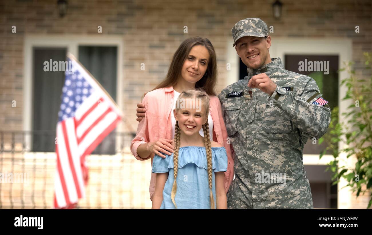 US military man with family showing keys from house, benefits in ...