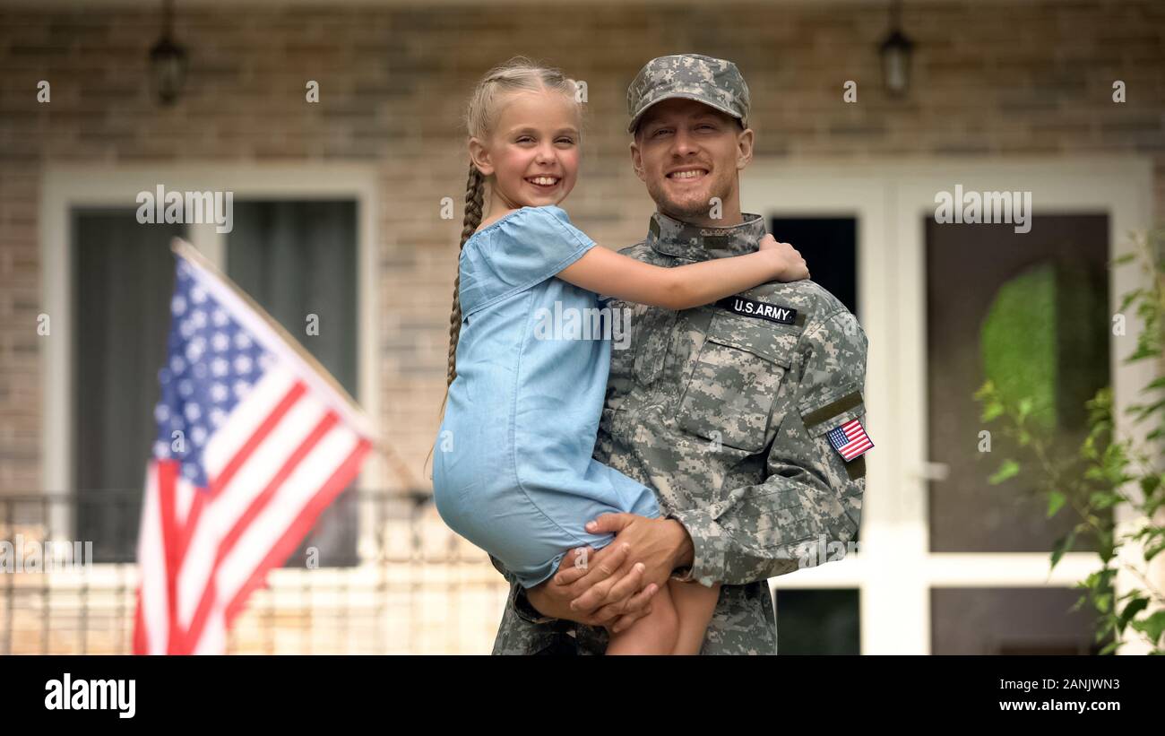 Handsome USA soldier in military uniform holding happy daughter ...