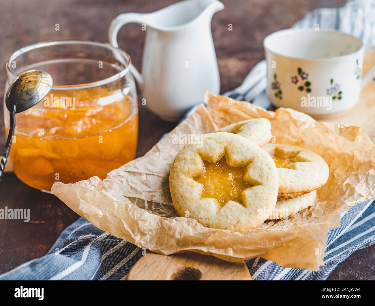 Fresh cookies and orange jam. Close-up, side view Stock Photo - Alamy