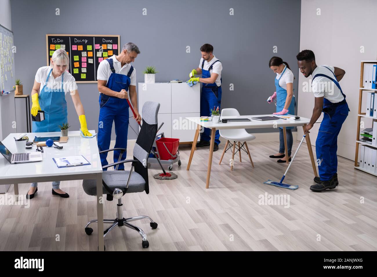 Group Of Janitors In Uniform Cleaning The Office With Cleaning ...