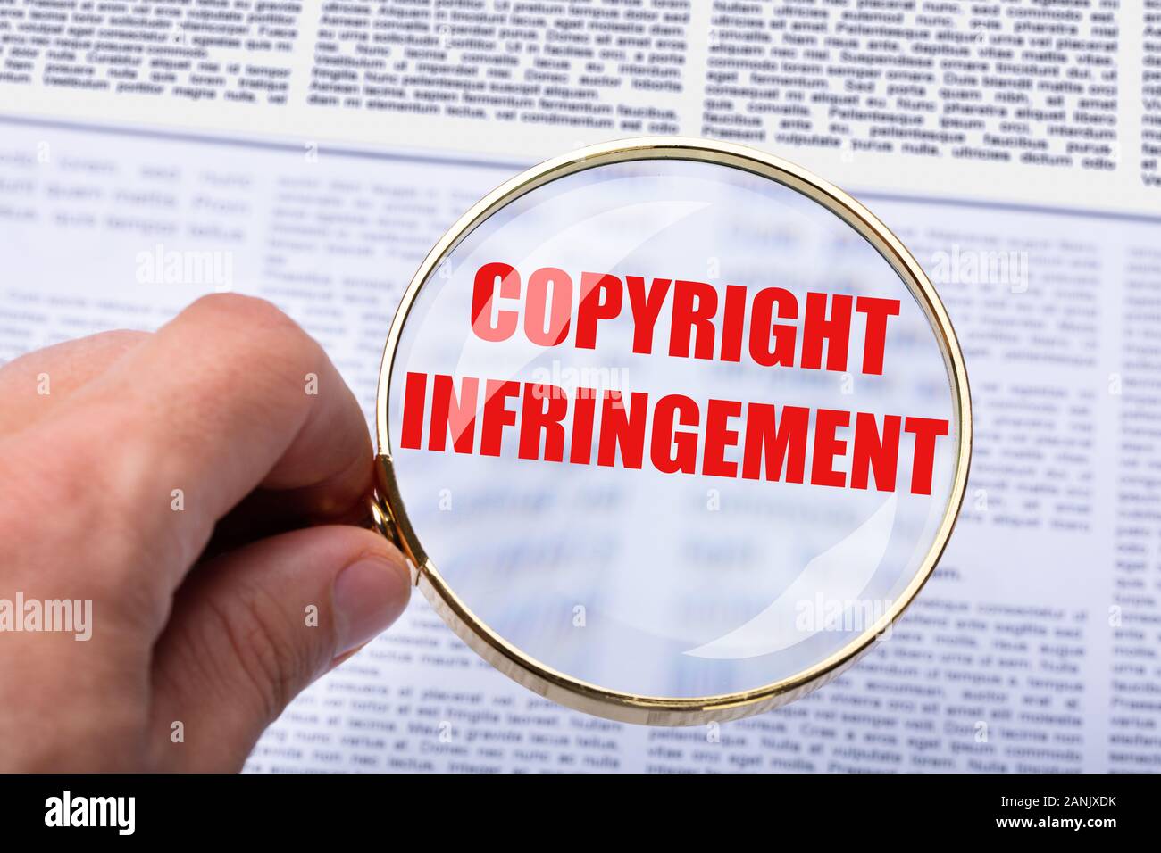 Close-up Of A Person's Hand Holding Magnifying Glass Over Copyright ...