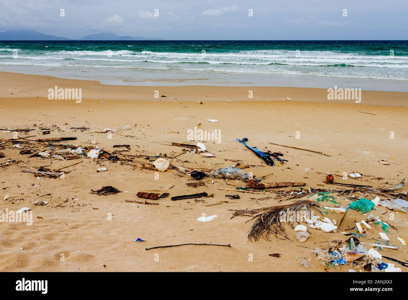 Garbage on the shore of a beautiful sea beach, environmental pollution ...