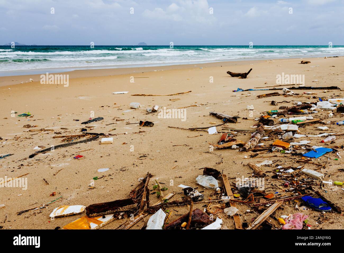 Garbage on the shore of a beautiful sea beach, environmental pollution ...