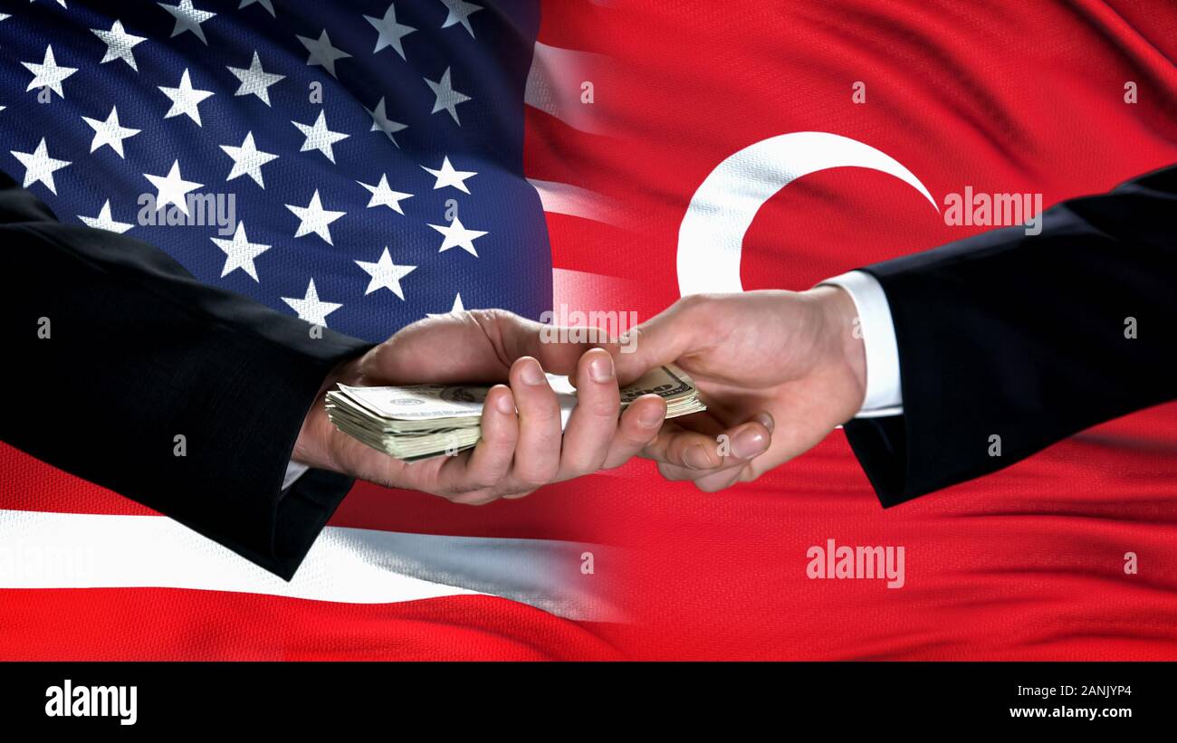 USA and Turkey officials exchanging money, flag background, country ...