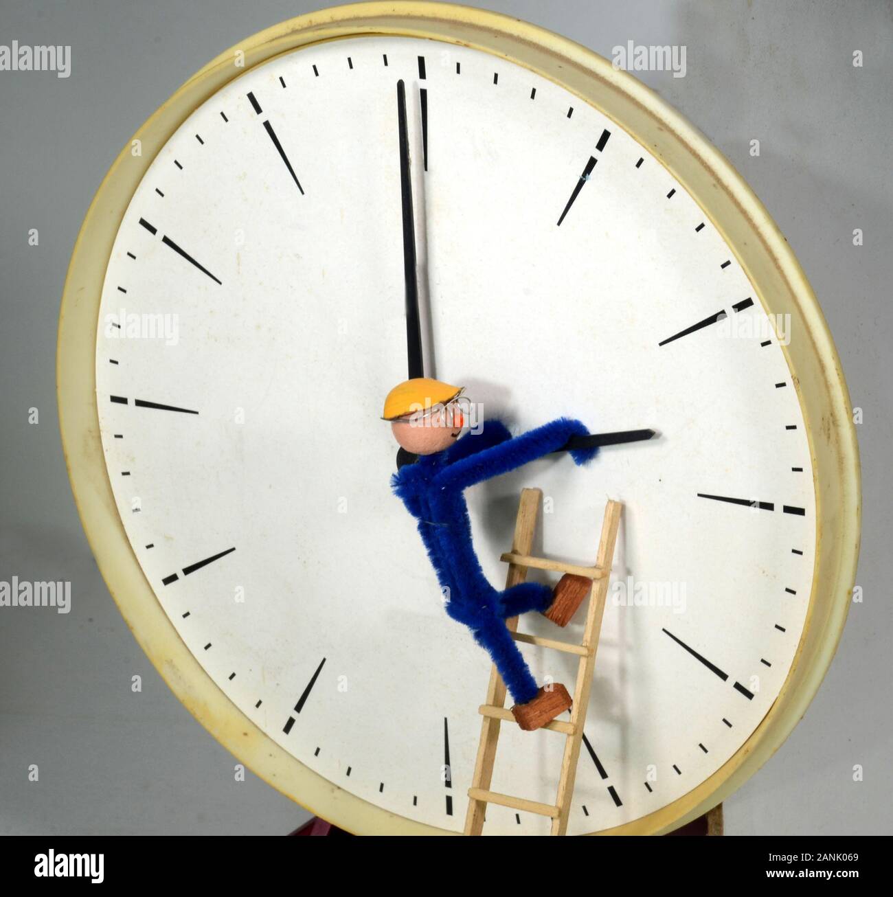 Clockman adjusting a clock to or back from Daylight Saving Time (DST ...