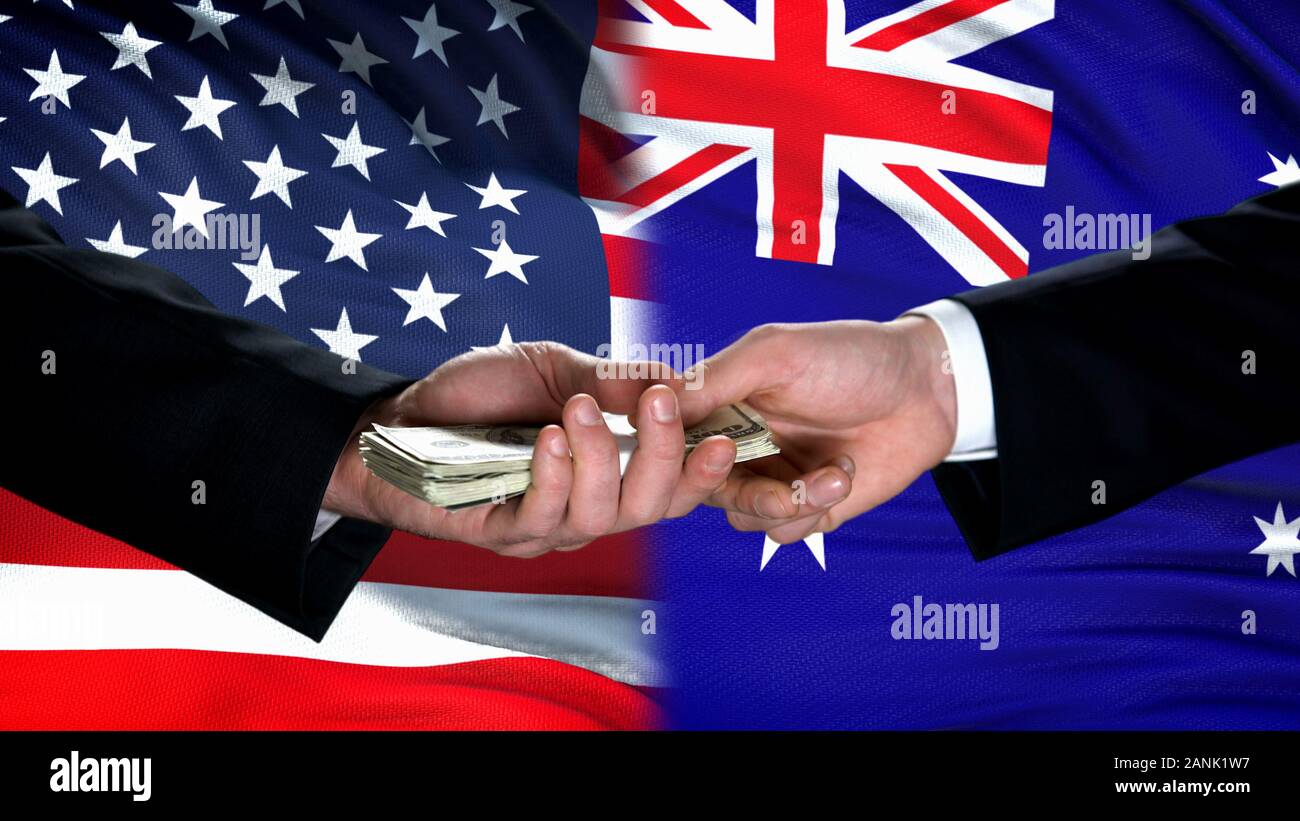 USA and Australia officials exchanging money, flag background, business ...
