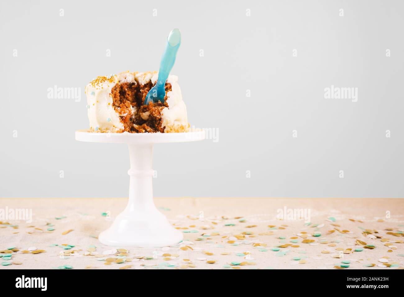 Damaged birthday cake with spoon. Birthday party celebration and ...