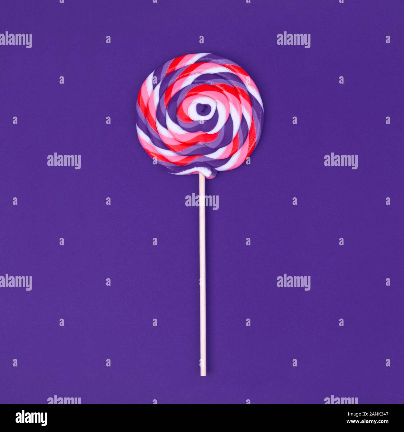 Big lollipop on solid ultra violet background. Square Stock Photo - Alamy