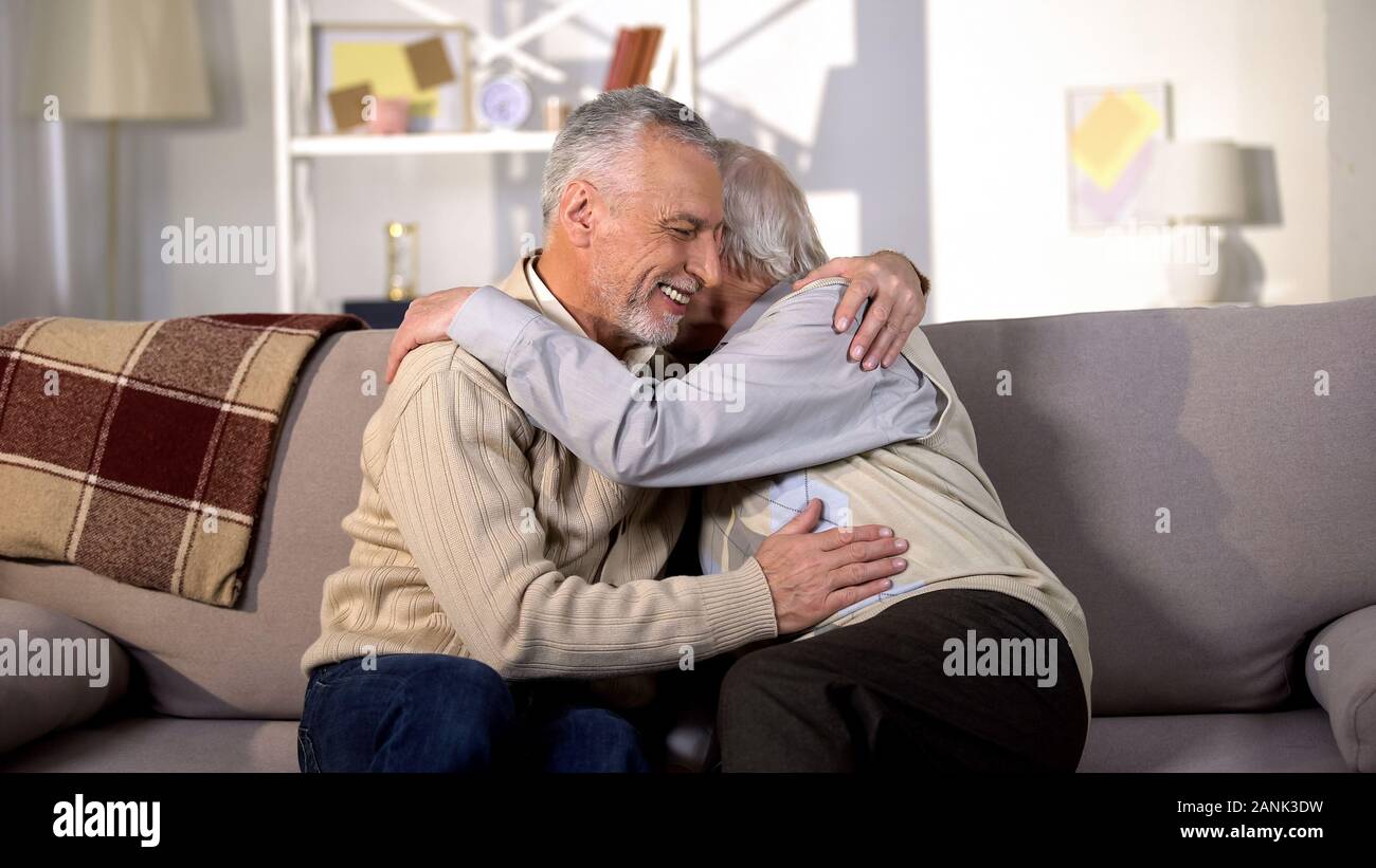 Old friends hugging hi-res stock photography and images - Alamy