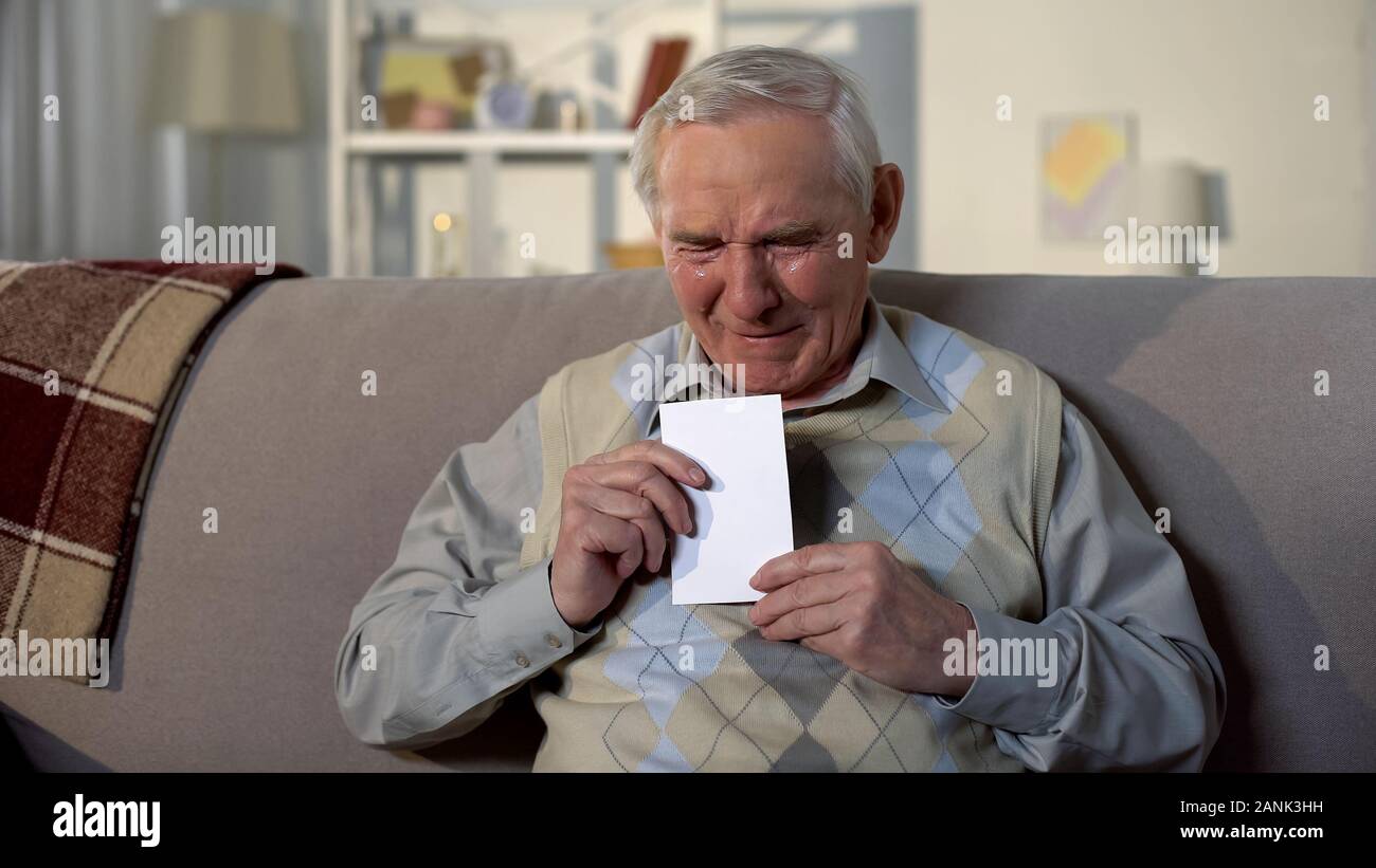 Depressed crying pensioner holding photo, old age loneliness, nostalgia ...