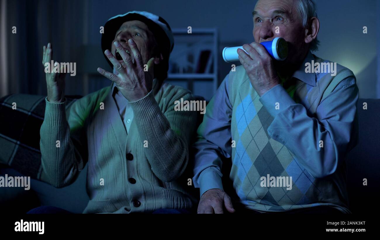 Aged football fans rooting for favorite team watching online game at ...