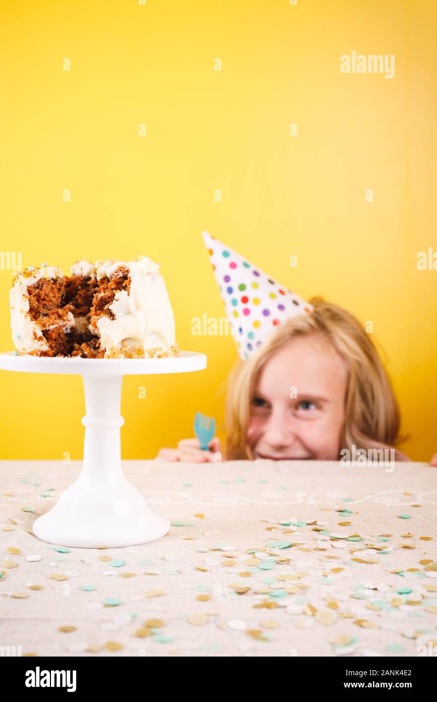 Teenage girl enjoying herself after ruining birthday cake. One person ...