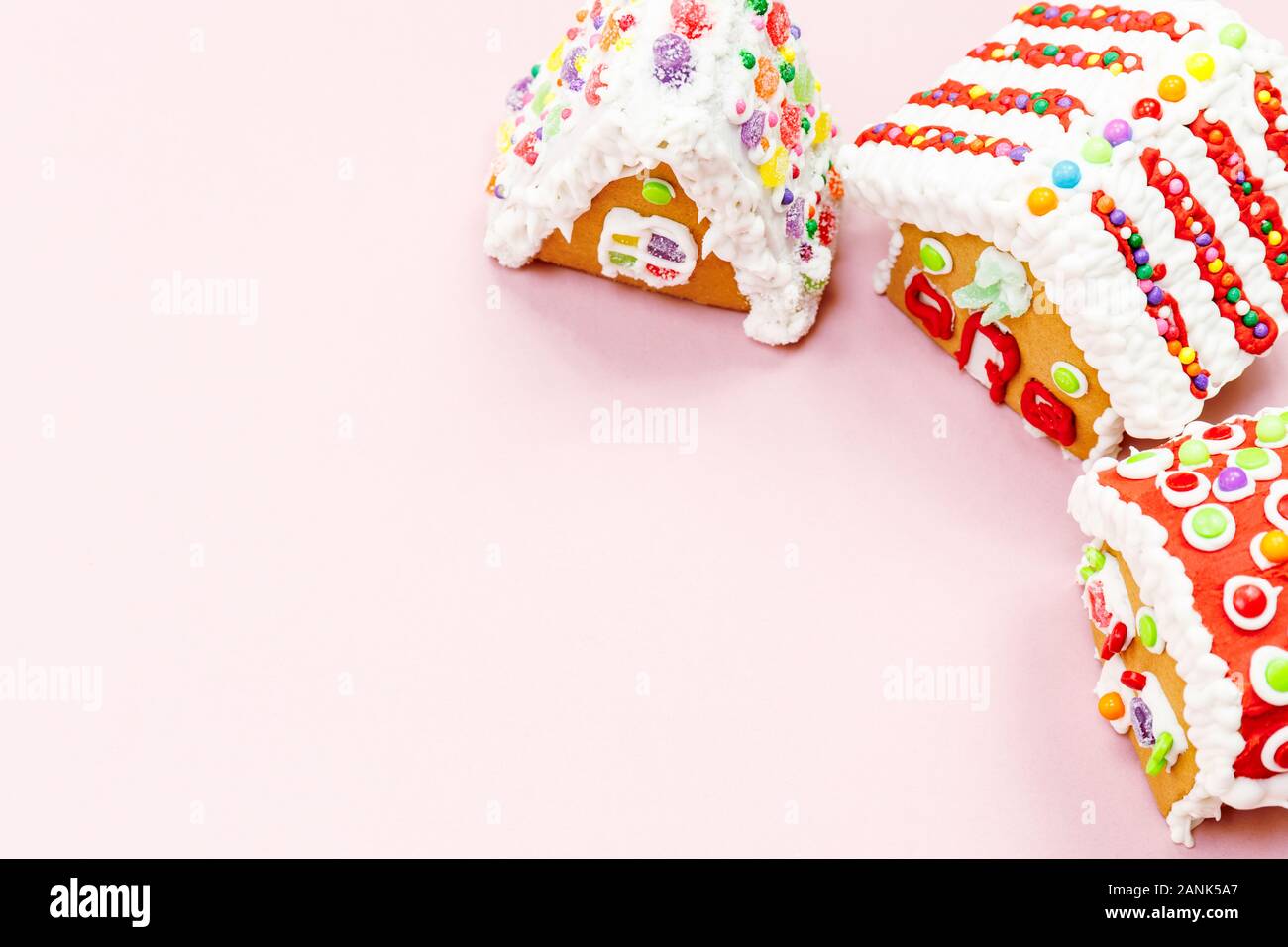 Gingerbread houses on the pink background. Christmas kids treats ...