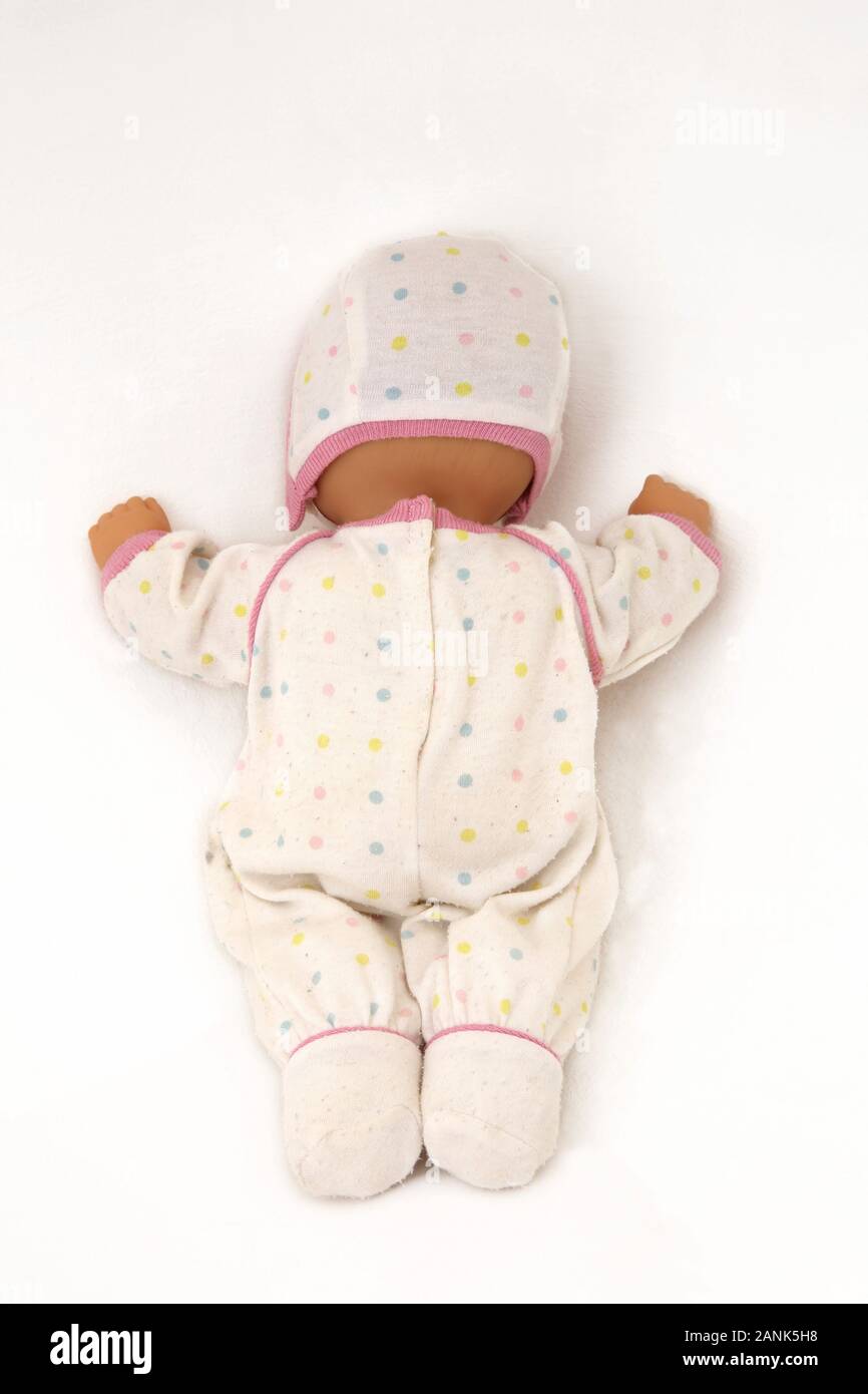 Back View Soft Body Doll with Polka Dot Babygro and Hat Stock Photo - Alamy