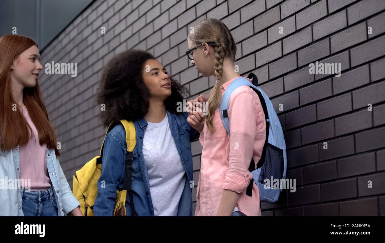 Teasing peers bullying modest classmate in eyeglasses, physical abuse ...