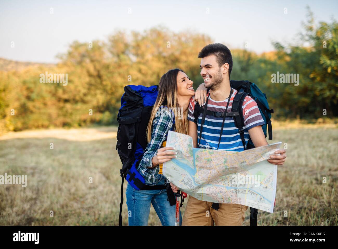 Young couple in the mountain. Portrait of beautiful young couple enjoying nature at mountain ...