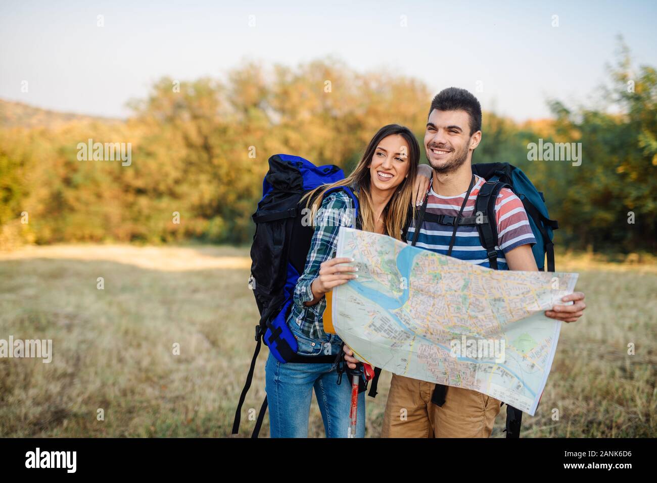 Young couple in the mountain. Portrait of beautiful young couple enjoying nature at mountain ...