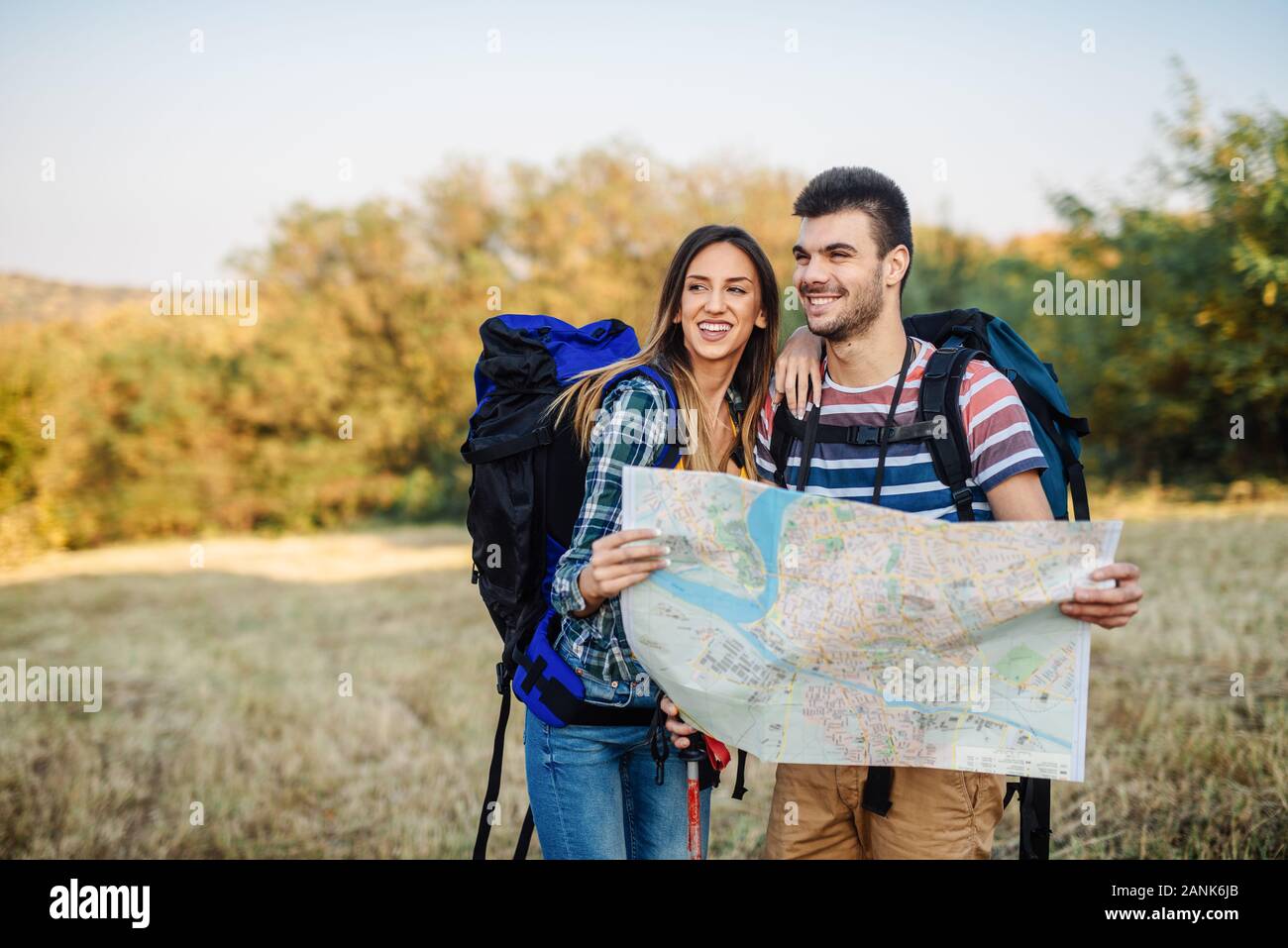 Young couple in the mountain. Portrait of beautiful young couple enjoying nature at mountain ...