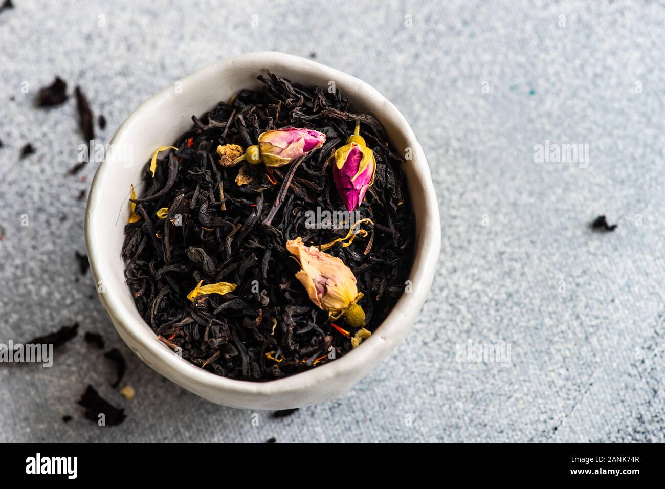 Different tea varieties in ceramic bowls on stone rustic background ...