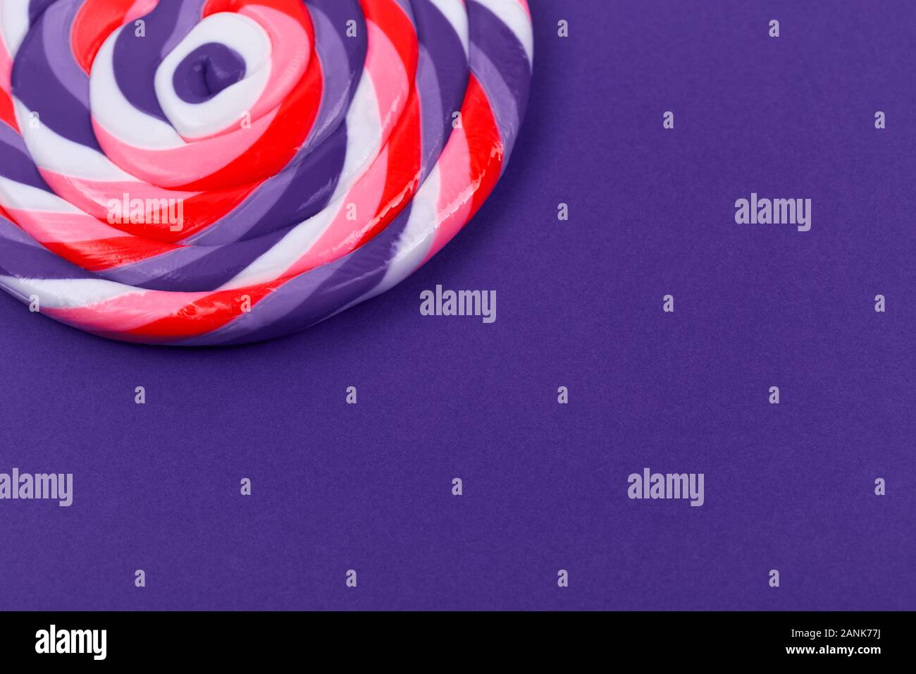 Big lollipop on solid ultra violet background. Horizontal, close up ...