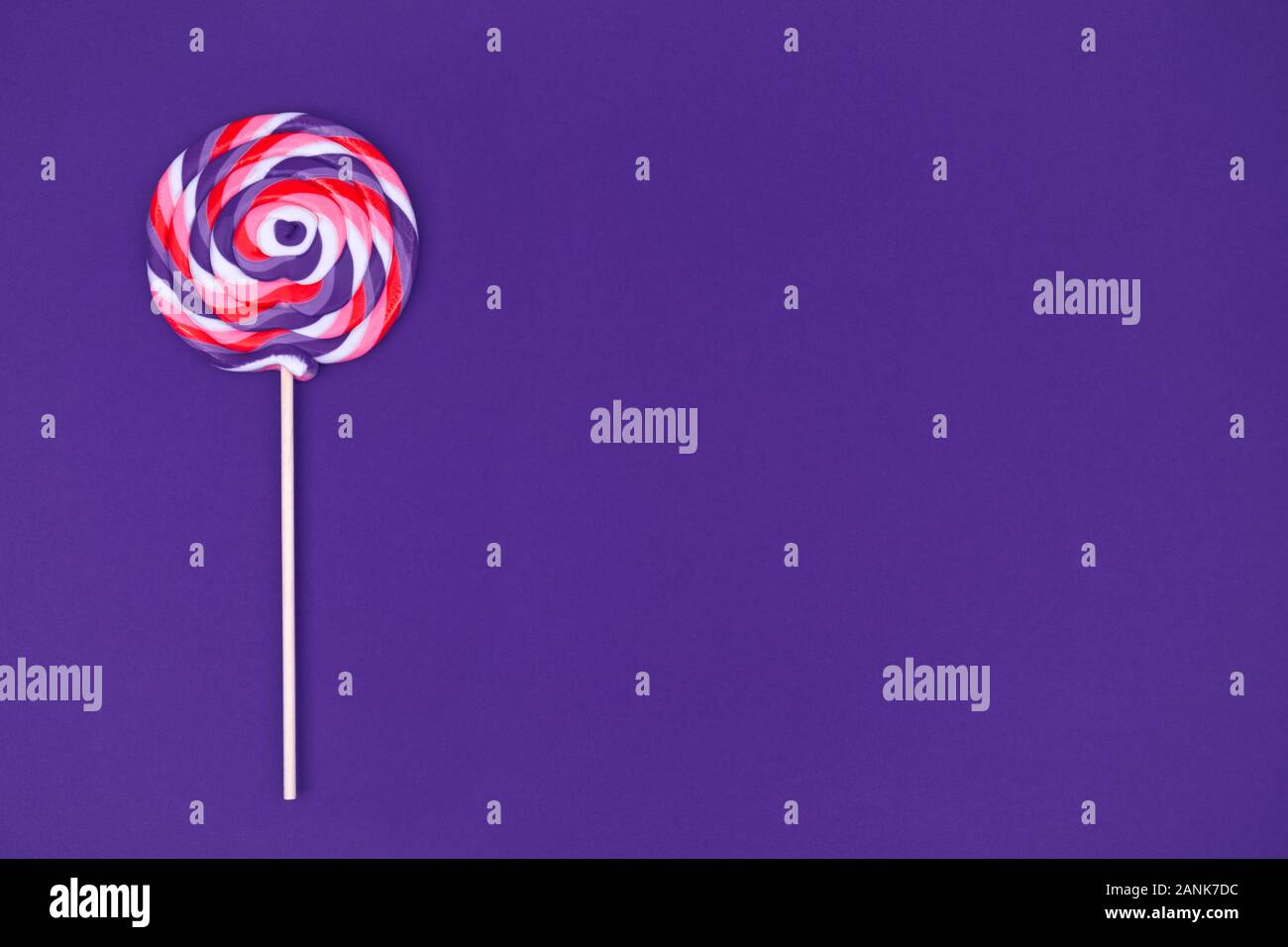 Big lollipop on solid ultra violet background. Horizontal Stock Photo ...