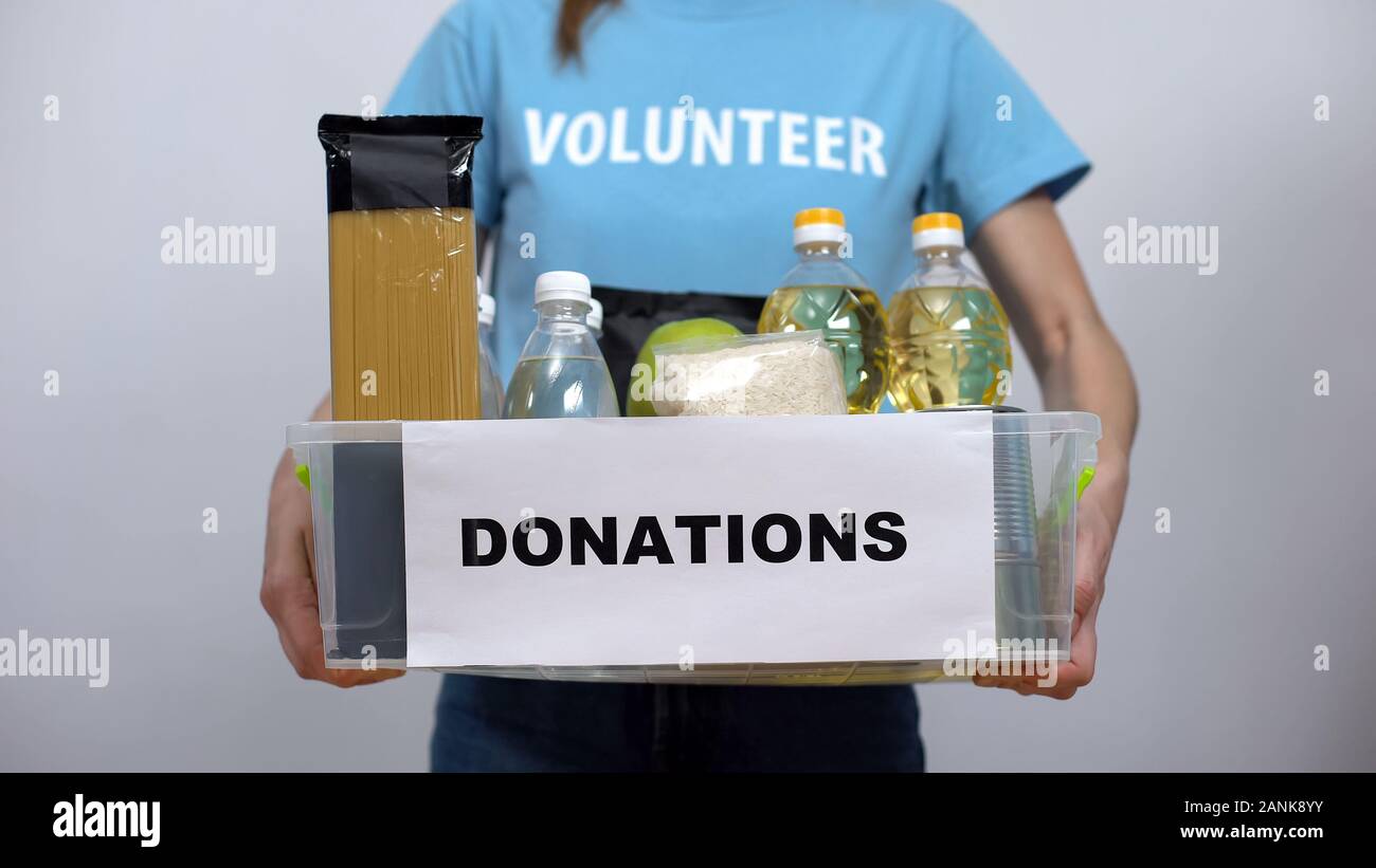 Hands putting food staff donation box, volunteer provision project ...