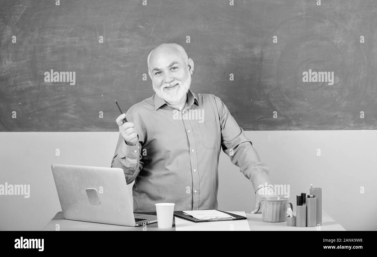 School teacher programming with laptop. Handsome man use modern ...