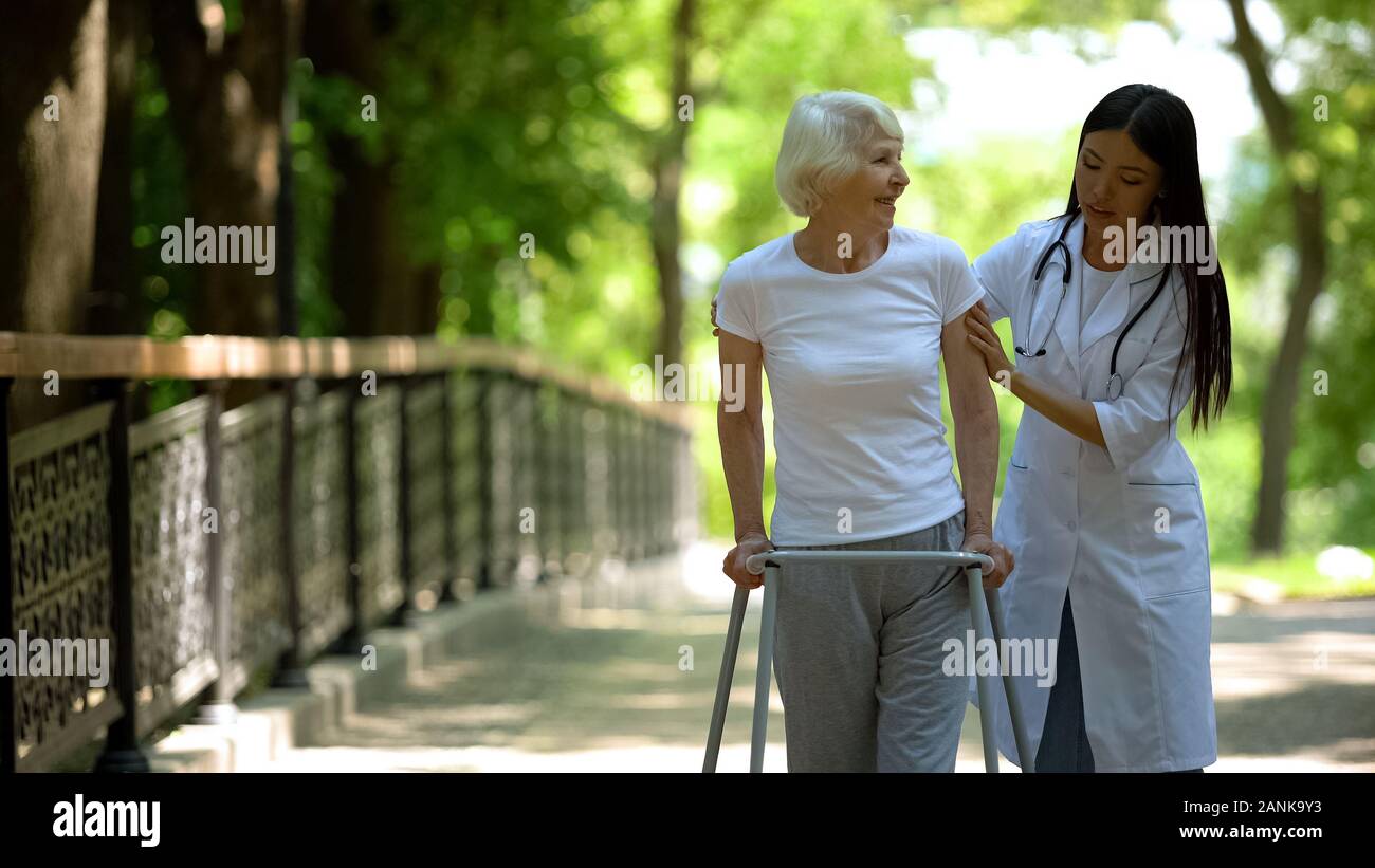 Nurse helping patient to walk hospital hi-res stock photography and ...