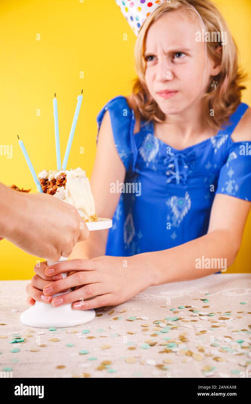 Teenage girl trying to keep birthday cake. One person party. Concept of ...