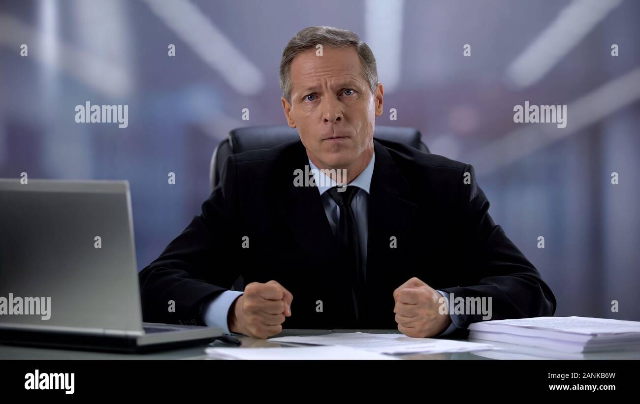 Angry boss with clenched fists looking at camera, failed task, material ...