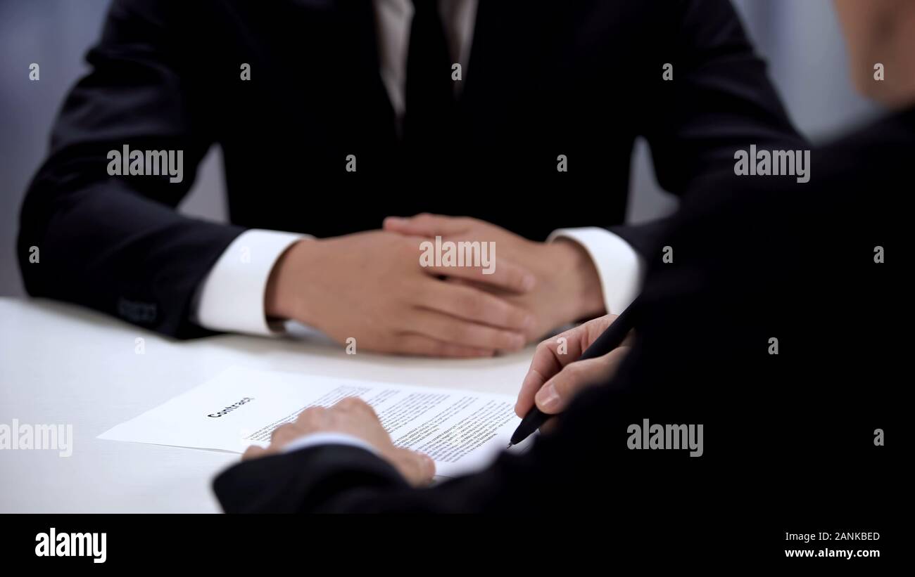 Businessmen colleagues signing contract, cooperation and partnership ...