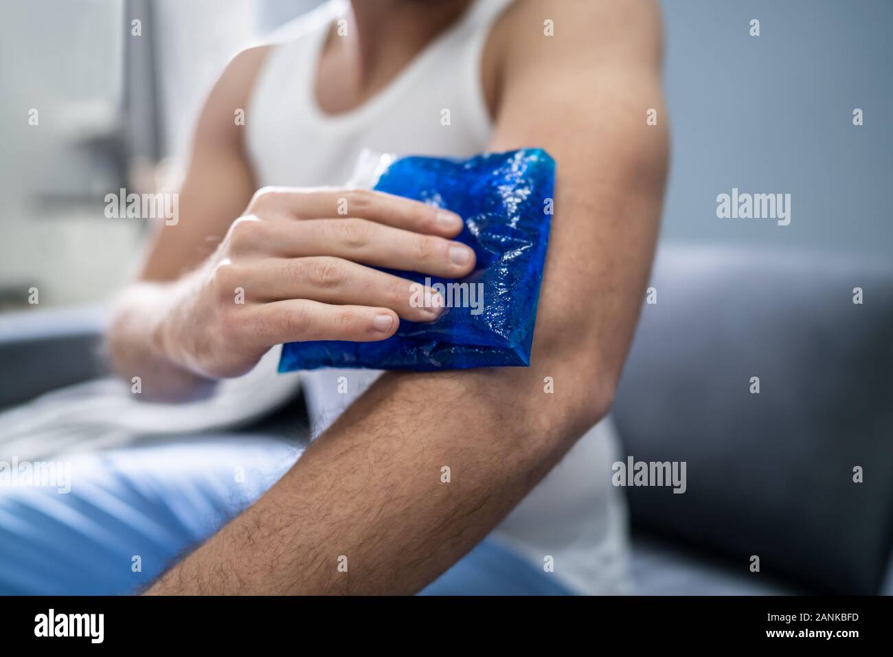 Close-up Of A Man's Hand Using Ice Gel Pack On Arm Stock Photo - Alamy