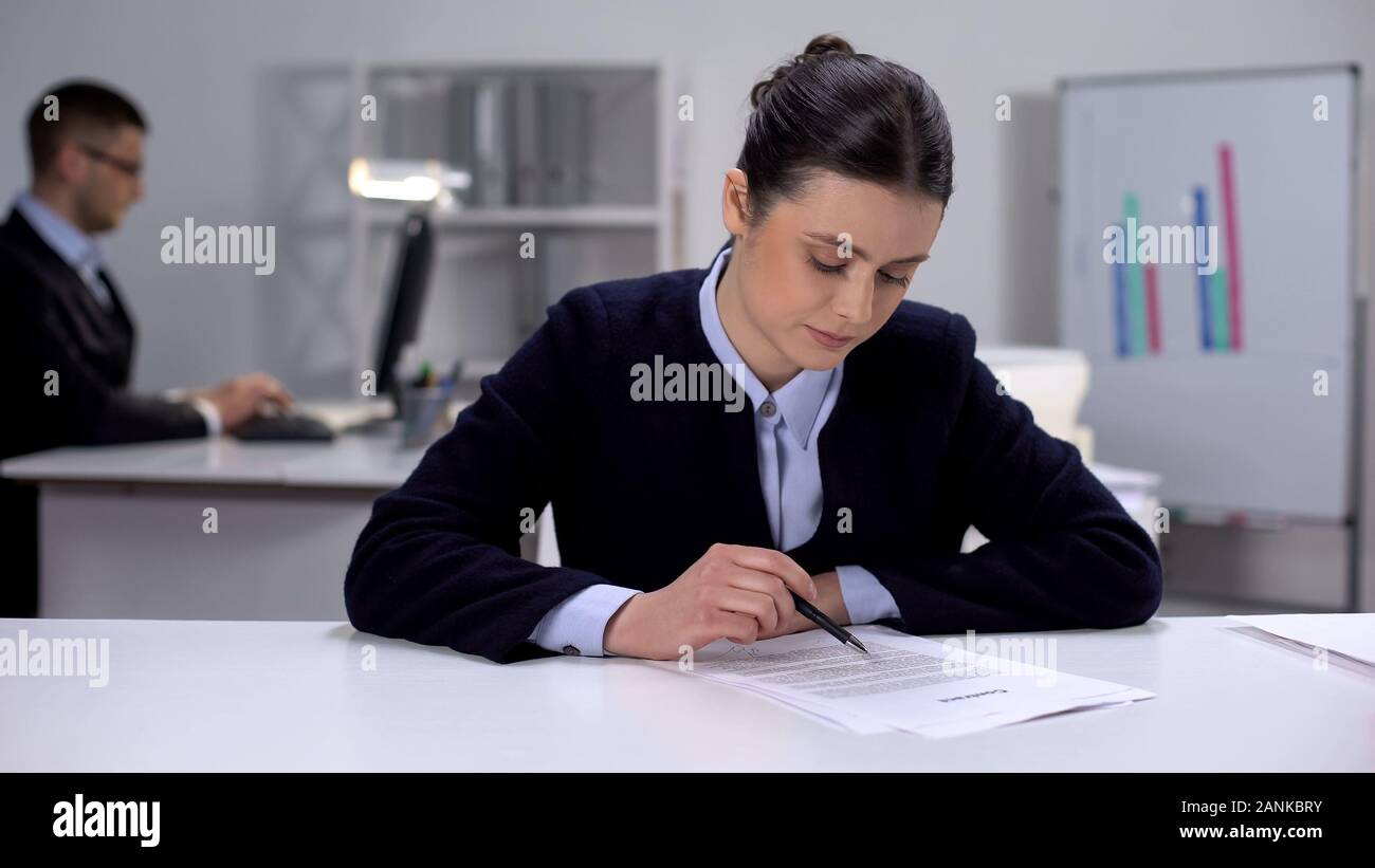 Female office manager working with documents, boring paper work ...