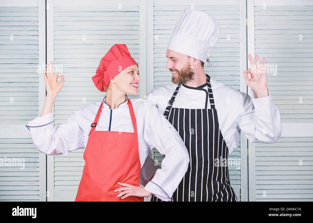 Two smiling chefs in kitchen. couple in love with perfect food. man and ...