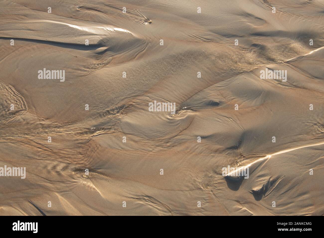 Flowing water over sand on beach Stock Photo - Alamy