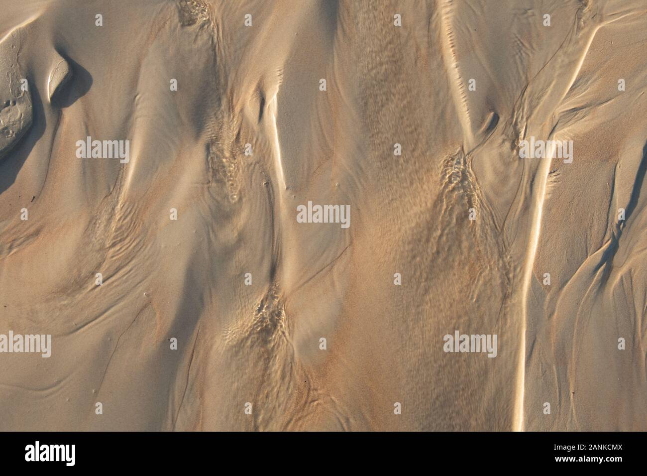 Flowing water over sand on beach Stock Photo - Alamy