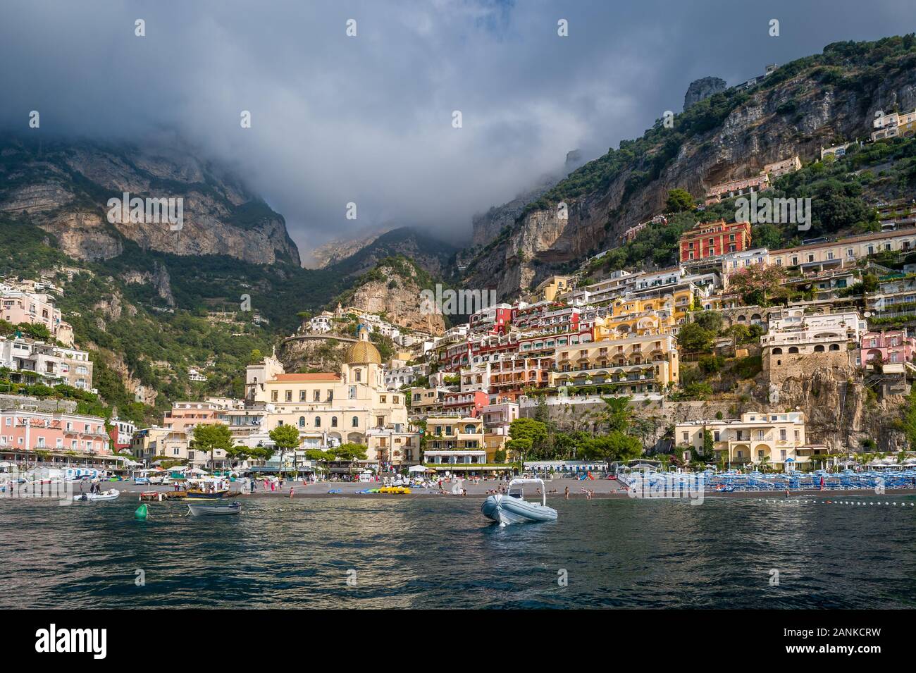Positano bay with beach, old town on the hill. Mountain range at the ...