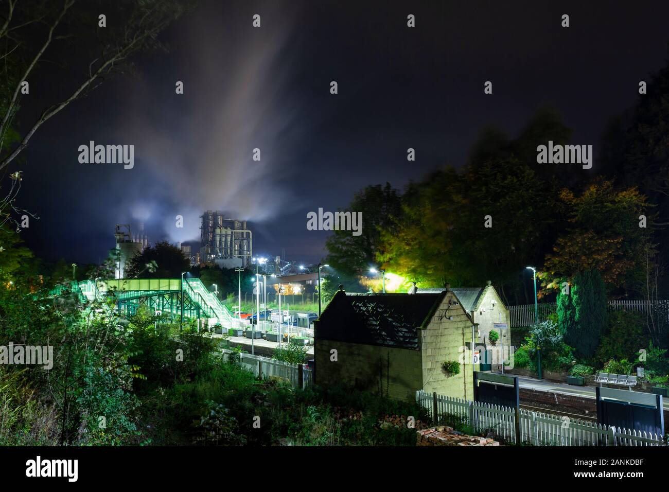 A night scene of Chirk railway station with clouds of steam and smoke ...