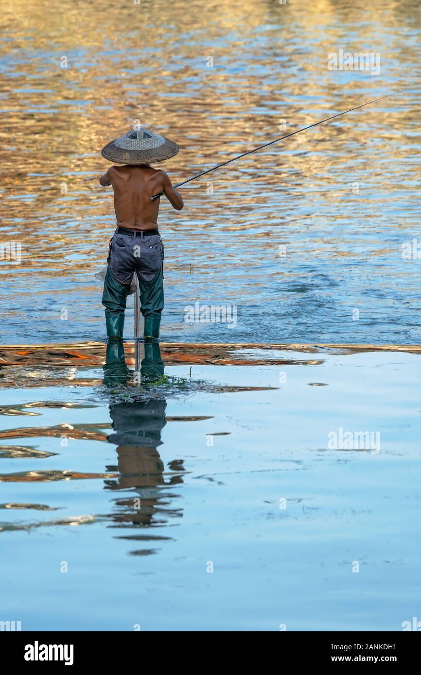 Feng Huang, China - August 2019 : Fisherman with a traditional ...