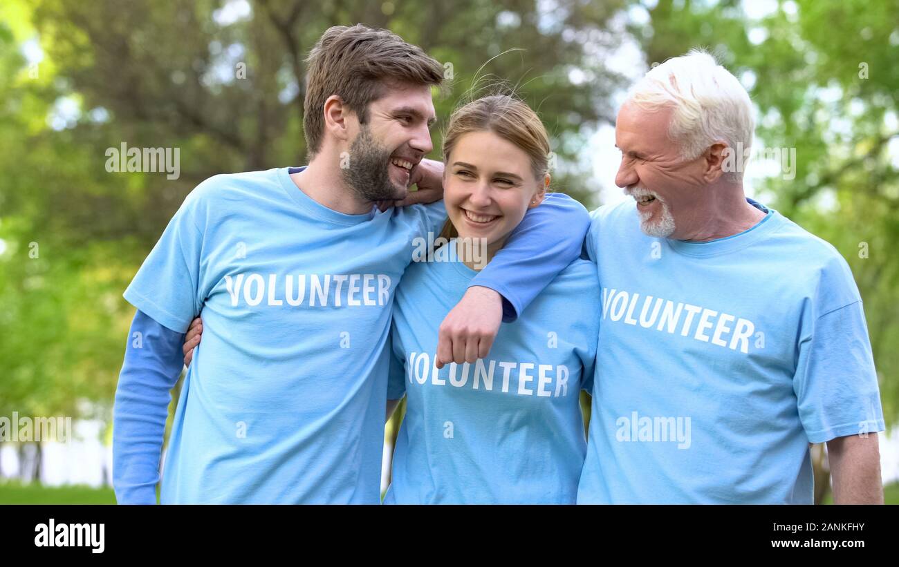 Group of happy volunteers hugging and smiling at park, teamwork ...