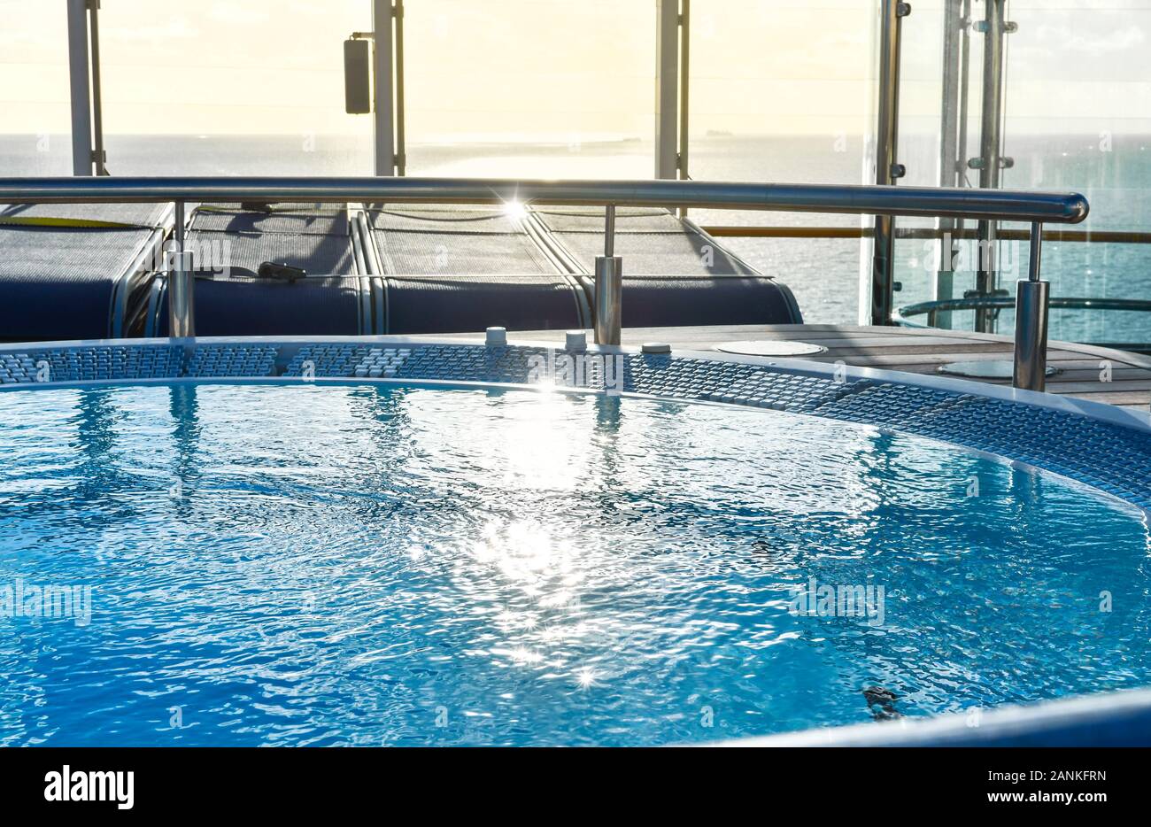 A close up shot of a cruise ship upper deck hot tub as the setting sun ...